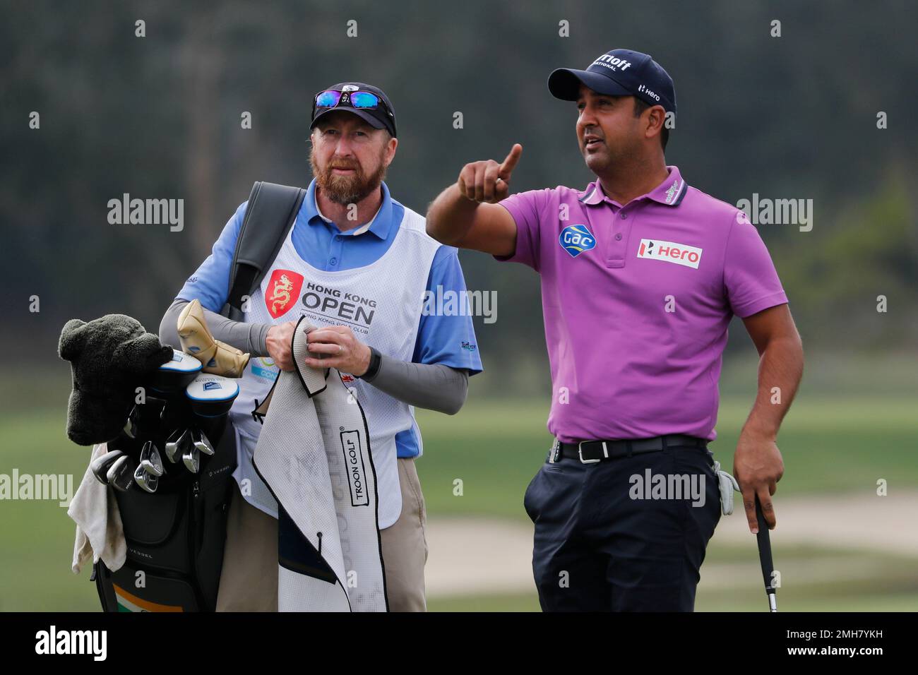 Shiv Kapur of India, right, chats with his caddie during the Hong Kong ...