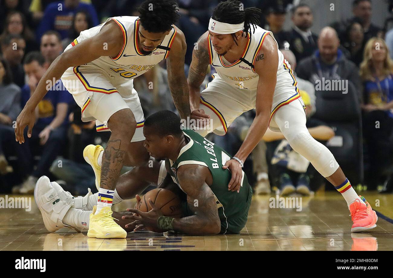 Milwaukee Bucks' Eric Bledsoe, center, keeps the ball from Golden State ...