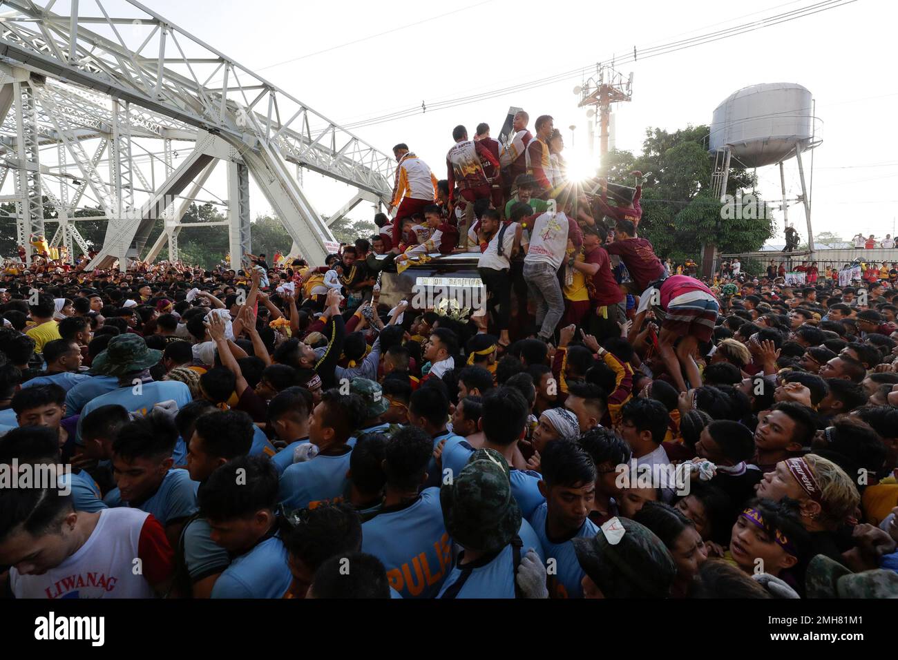A crowd of Filipino Roman Catholic devotees follow the carriage of the ...