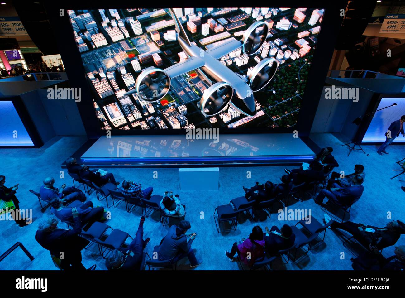 People watch a display with the Bell Nexus 4EX, a four-duct electric or ...