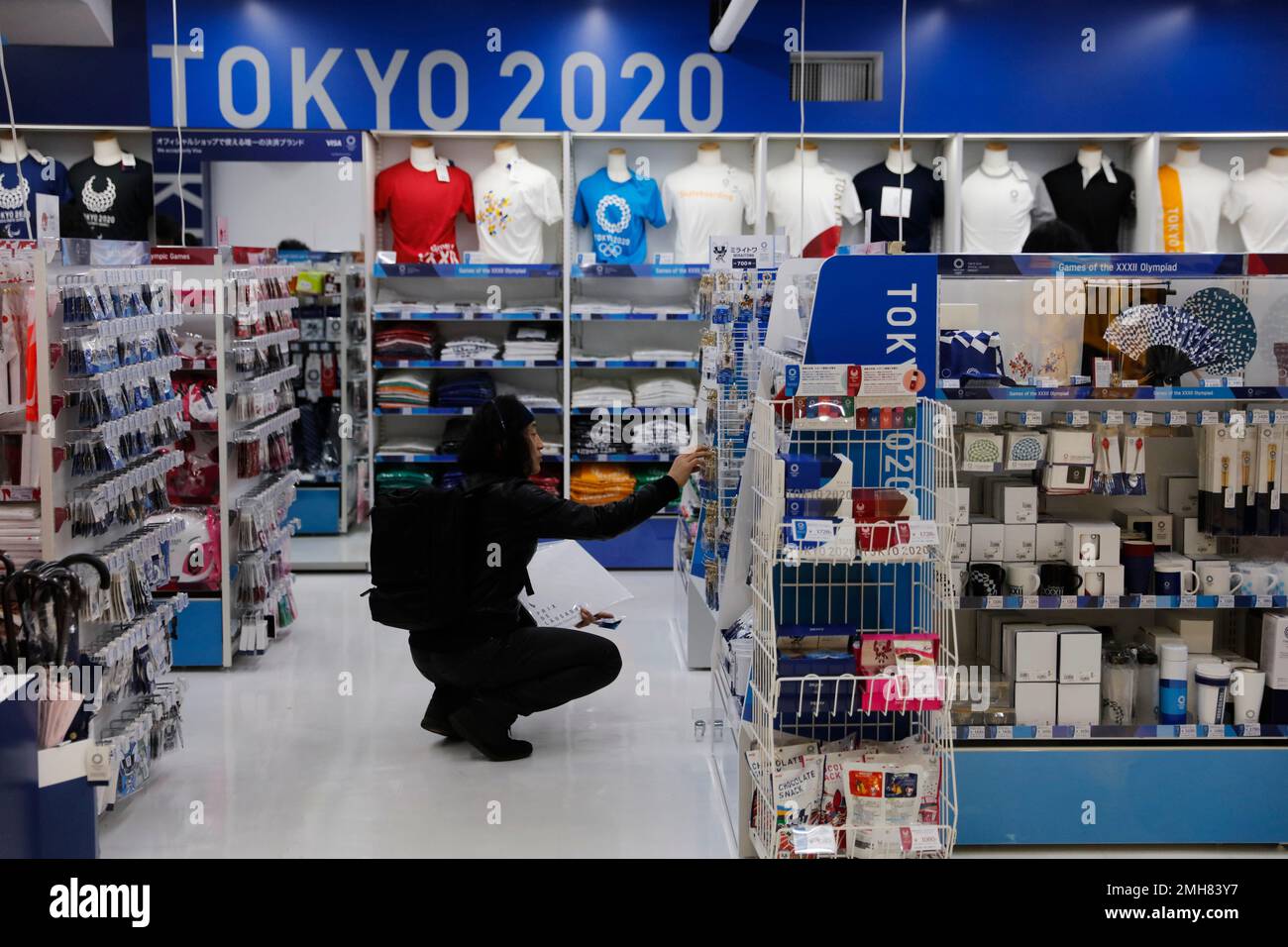 A man looks at Olympic souvenirs at a Tokyo 2020 official shop in the ...