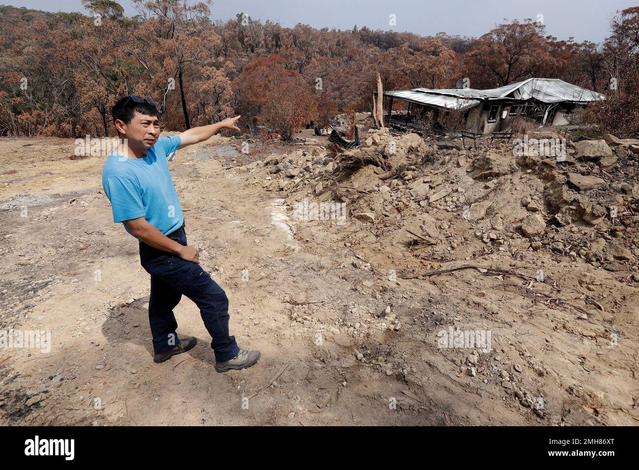 Justin Kam surveys his destroyed home at Balmoral, Australia, Tuesday ...