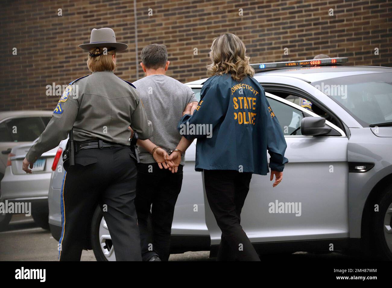 Connecticut State Police officers lead Fotis Dulos, center, from the ...