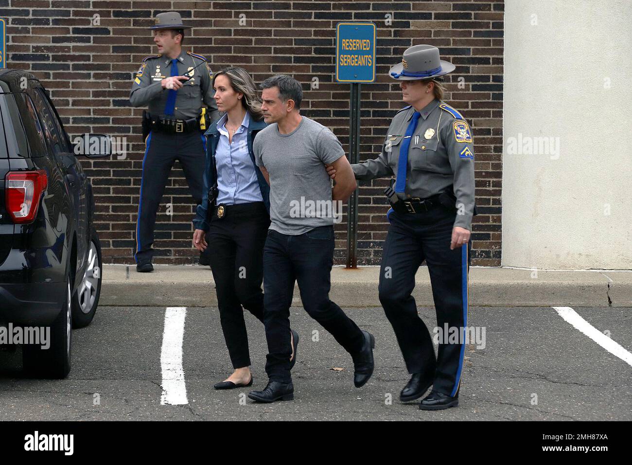 Connecticut State Police officers lead Fotis Dulos, center, from the ...