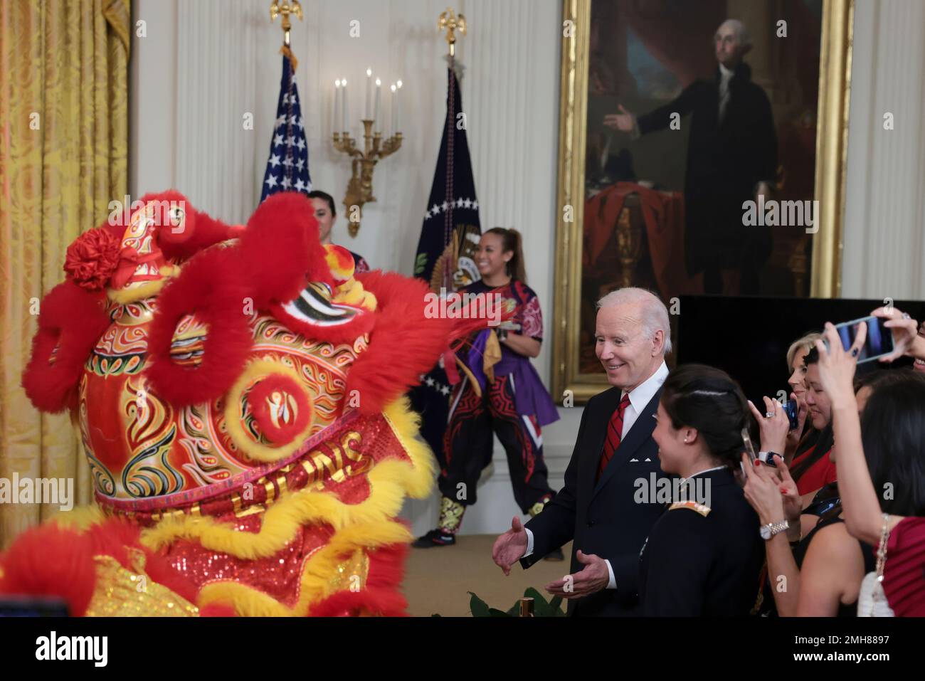 U.S. President Joe Biden reacts as a dragon, part of the The Choy Wun ...