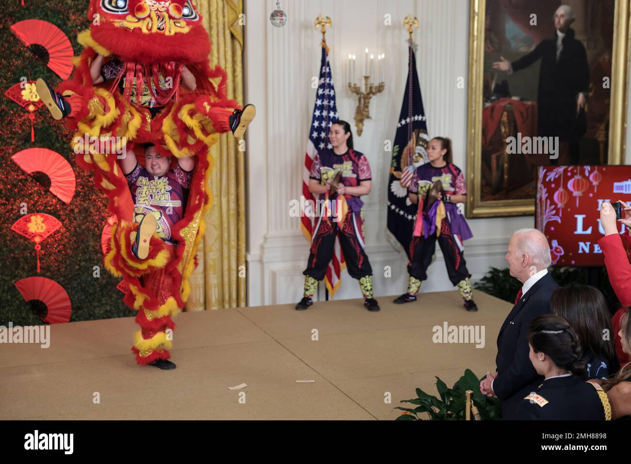 U.S. President Joe Biden looks on as members of the The Choy Wun Lion ...
