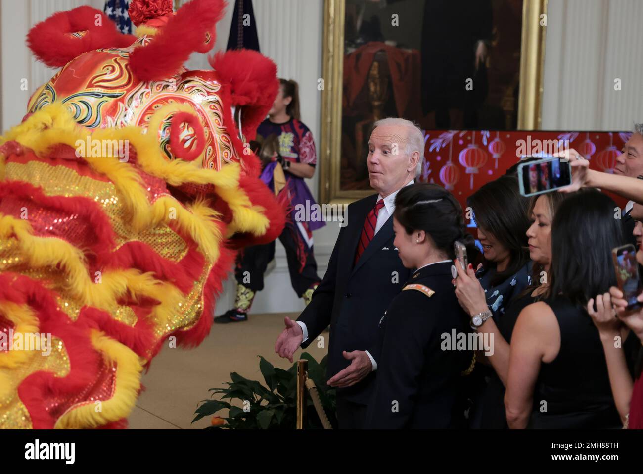 U.S. President Joe Biden reacts as members of the The Choy Wun Lion ...