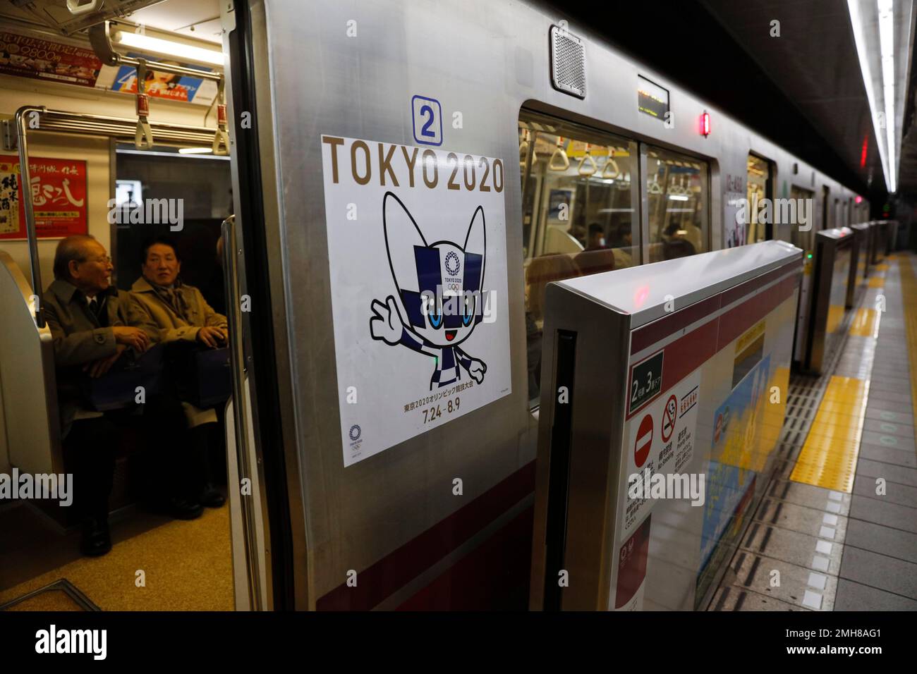 A Tokyo 2020 sign is posted next to the doors of a train Tuesday, Jan ...