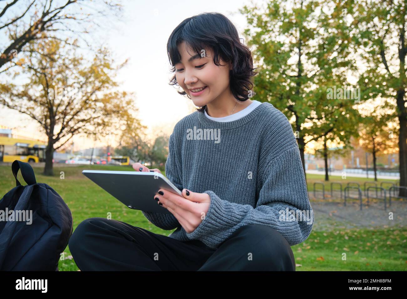 Portrait of young smiling korean girl, graphic designer, artist drawing ...