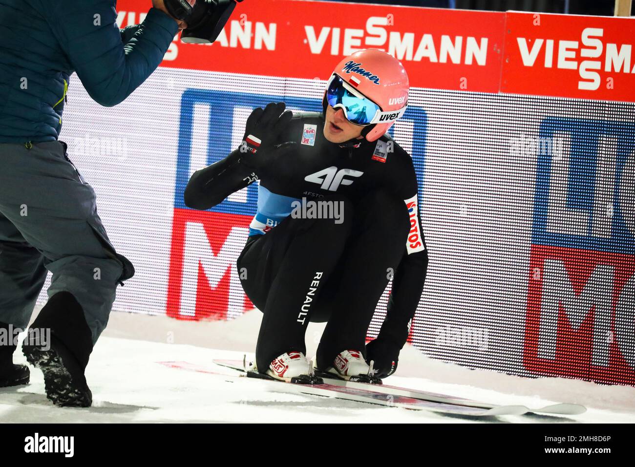 Dawid Kubacki of Poland waves to a television camera after his first ...