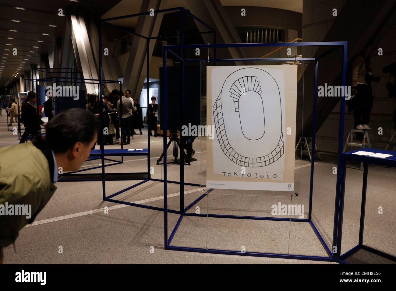 A journalist looks at a poster created by Philippe Weisbecker, one of ...