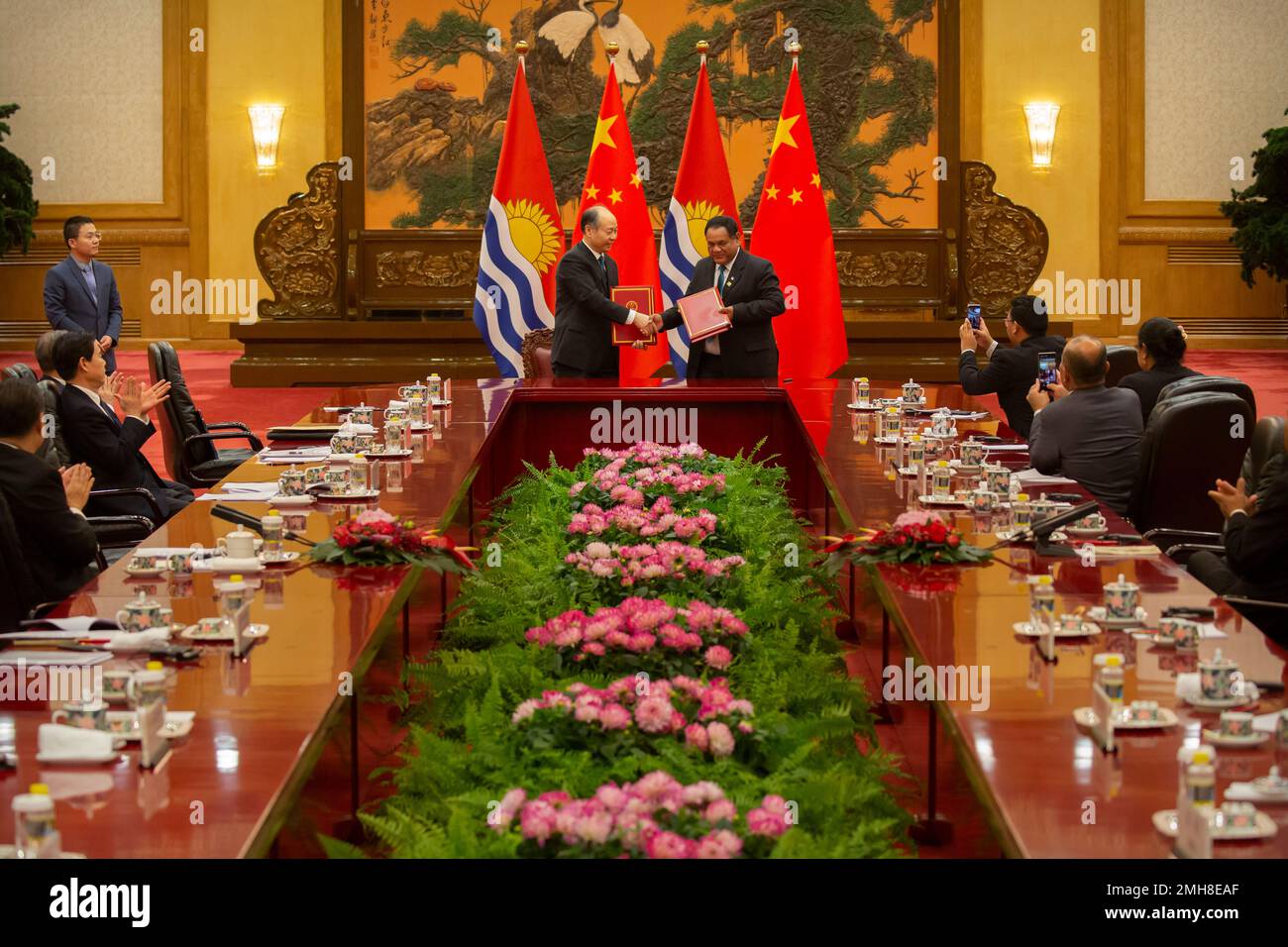 Members of China's and Kiribati's governments attend a signing ceremony ...