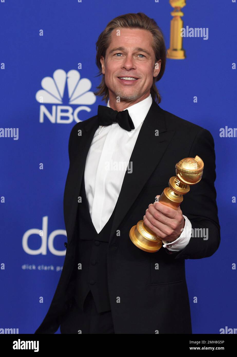 Brad Pitt poses in the press room with the award for best performance ...