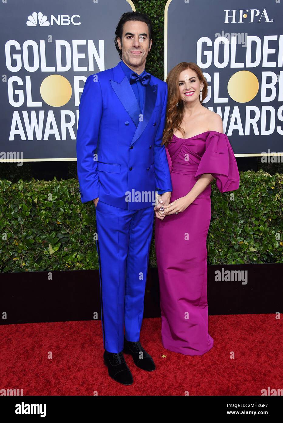 Sacha Baron Cohen, left, and Isla Fisher arrive at the 77th annual ...