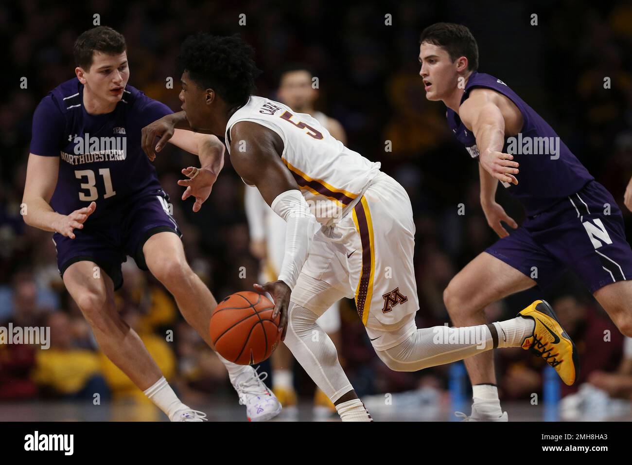 Minnesota's Marcus Carr drives the ball past Northwestern's Robbie ...