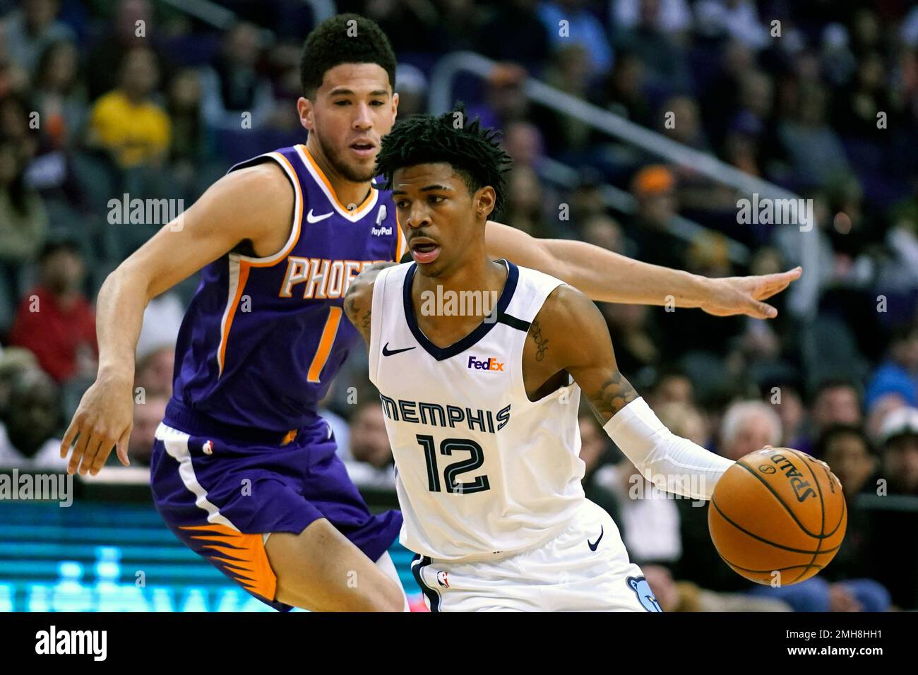 Memphis Grizzlies guard Ja Morant (12) drives past Phoenix Suns guard ...