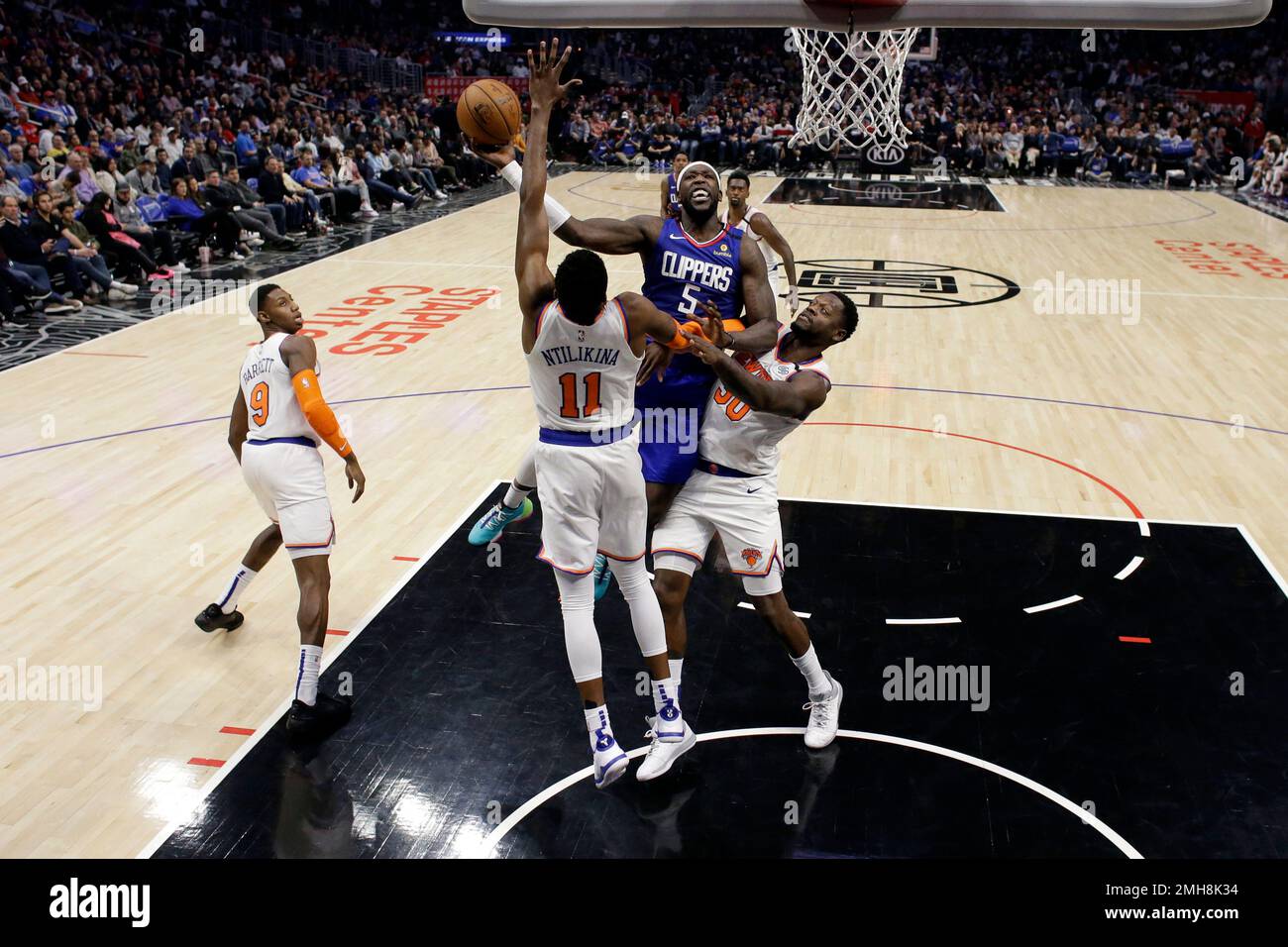 Los Angeles Clippers' Montrezl Harrell (5) is defended by New York ...