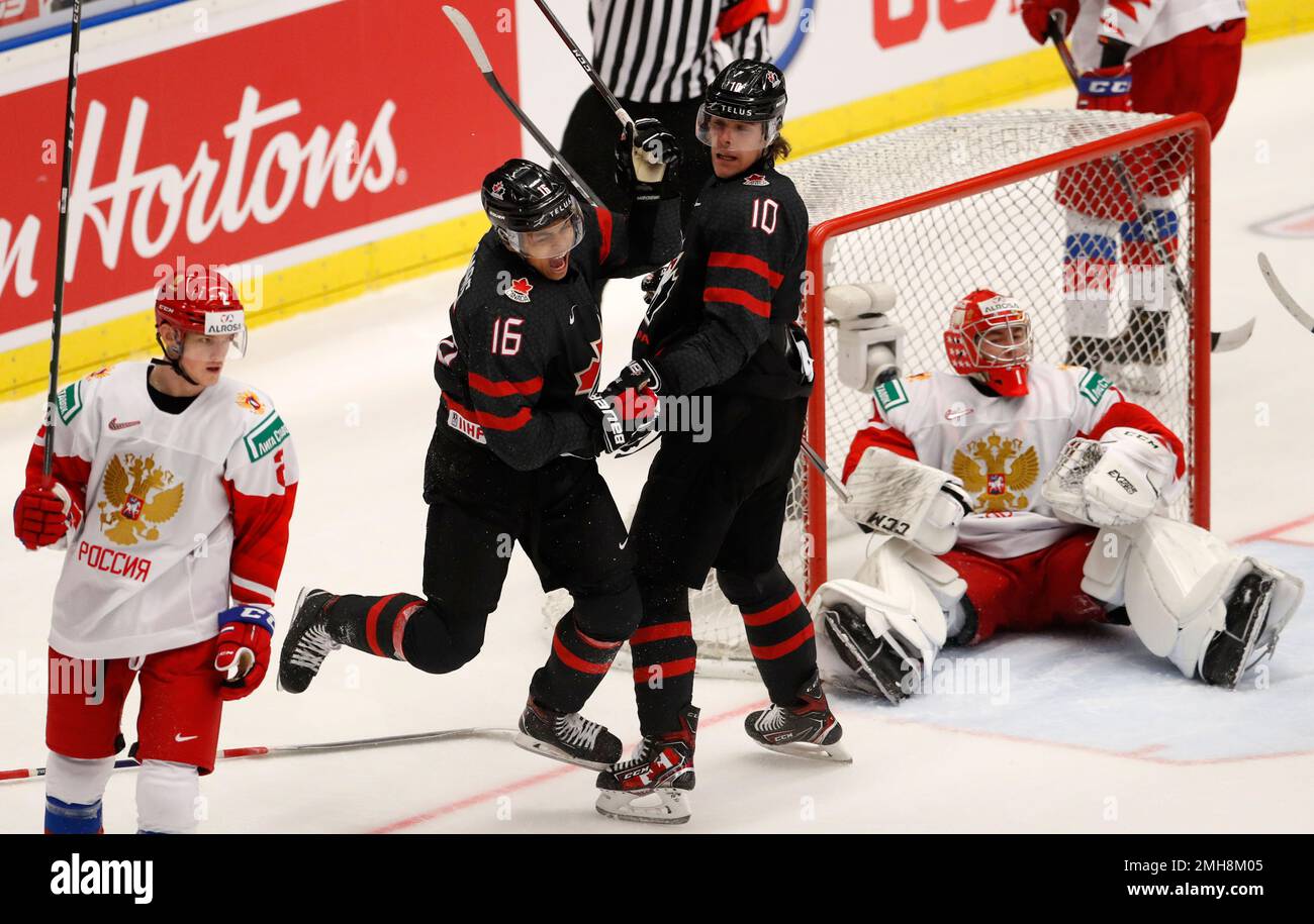 Canada's Akil Thomas, 2nd left, celebrates with Canada's Raphael Lavoie ...
