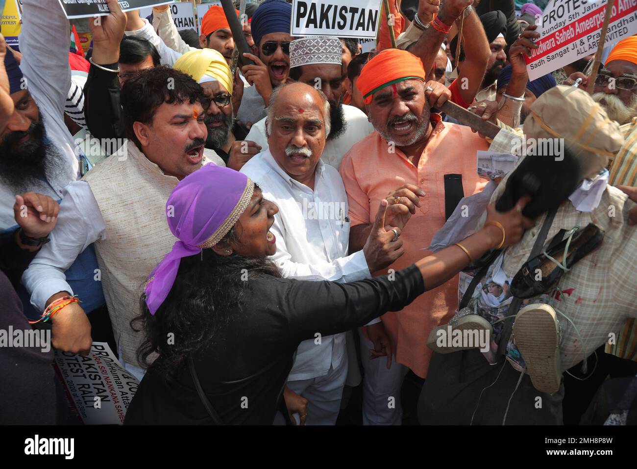 An Indian woman slaps an effigy of Pakistan Prime Minister Imran Khan ...