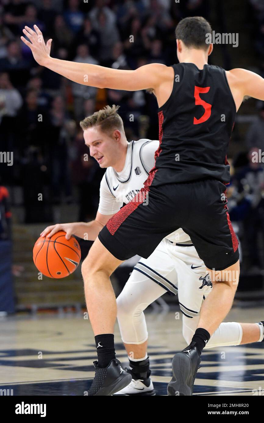 Utah State guard Sam Merrill, left, is defended by San Diego State ...