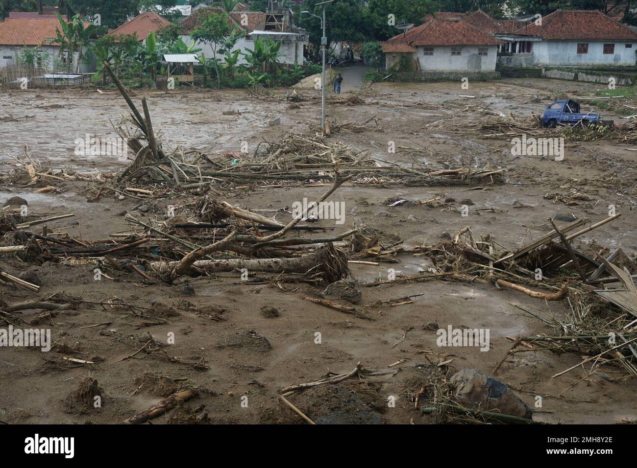 Debris are scattered on a field at a village hit by a landslide in ...