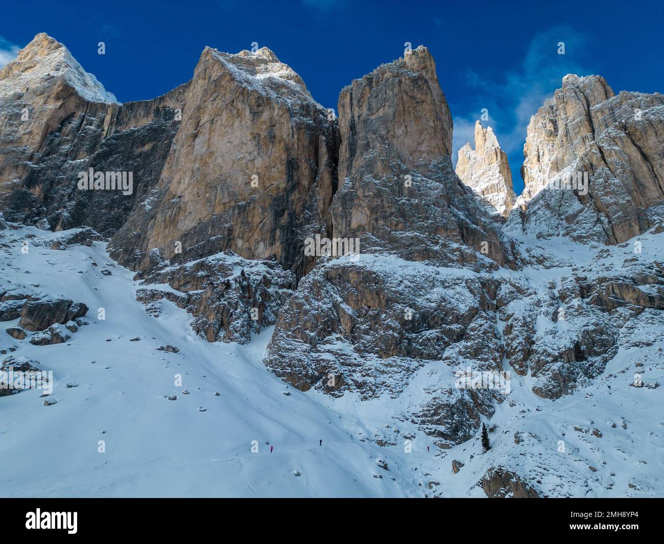 Tiny hikers on a winter trail towards Vajolet Refuge from Vigo di Fassa ...