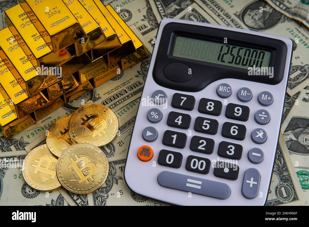 Gold bars with calculator on dollar bills background and bitcoin ...