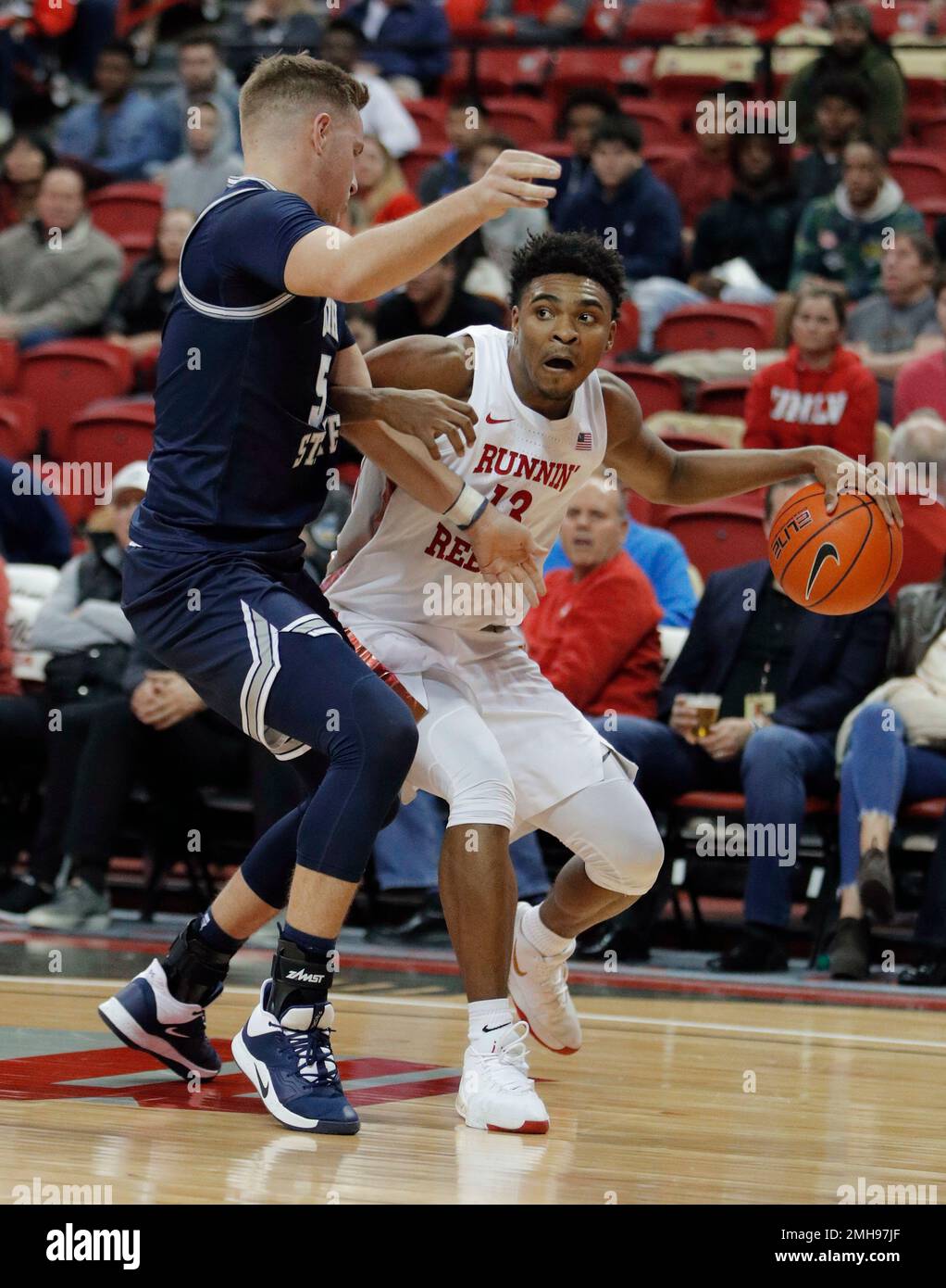 UNLV's Bryce Hamilton (13) drives around Utah State's Sam Merrill ...