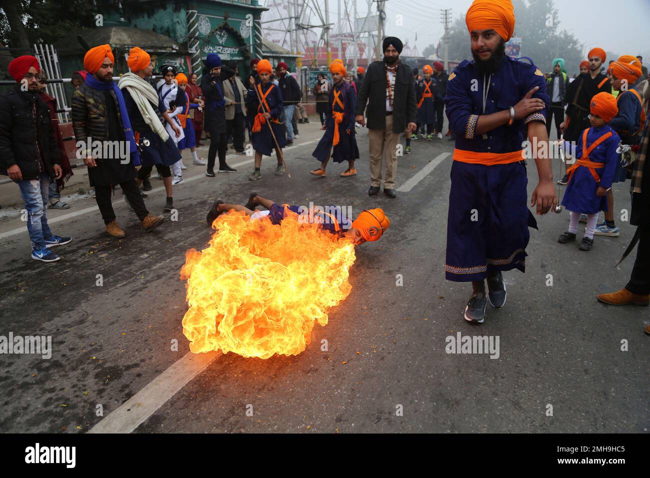An Indian Sikh warrior blows fire as he displays traditional martial ...