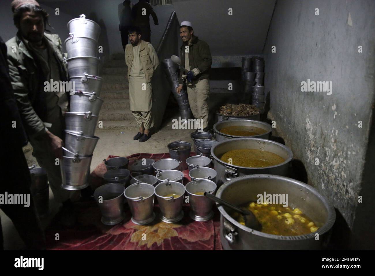 In this Saturday, Dec. 14, 2019, photo, cooks prepare dinner food for ...
