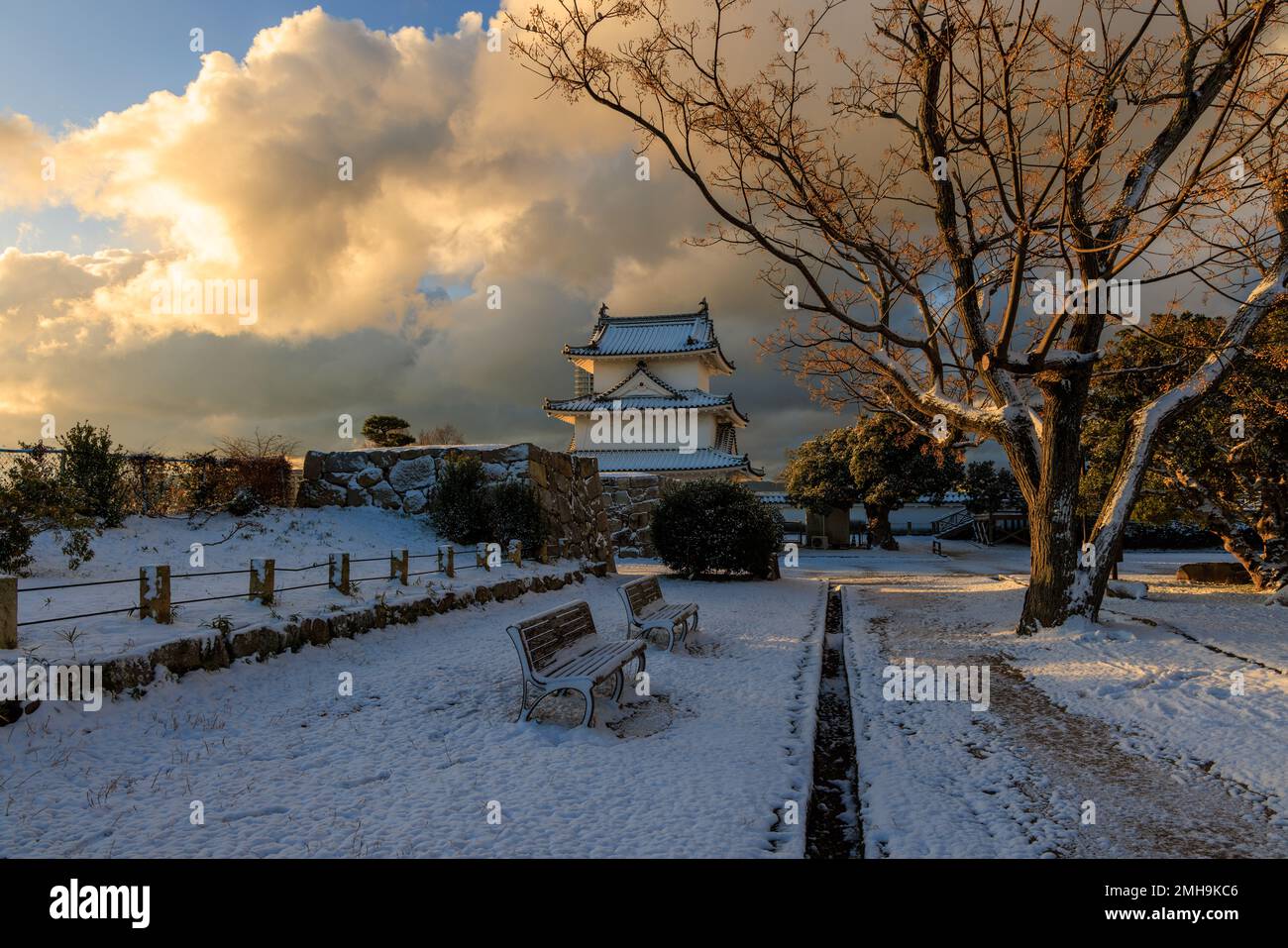 Beautiful sunrise light on historic Japanese castle on snowy winter ...