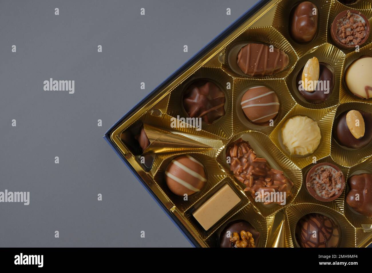 Assorted chocolate candies on a gray background.Milk chocolate candy ...