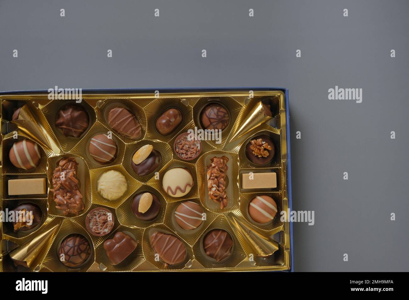 Sweets and desserts. Assorted chocolate box on a gray background ...
