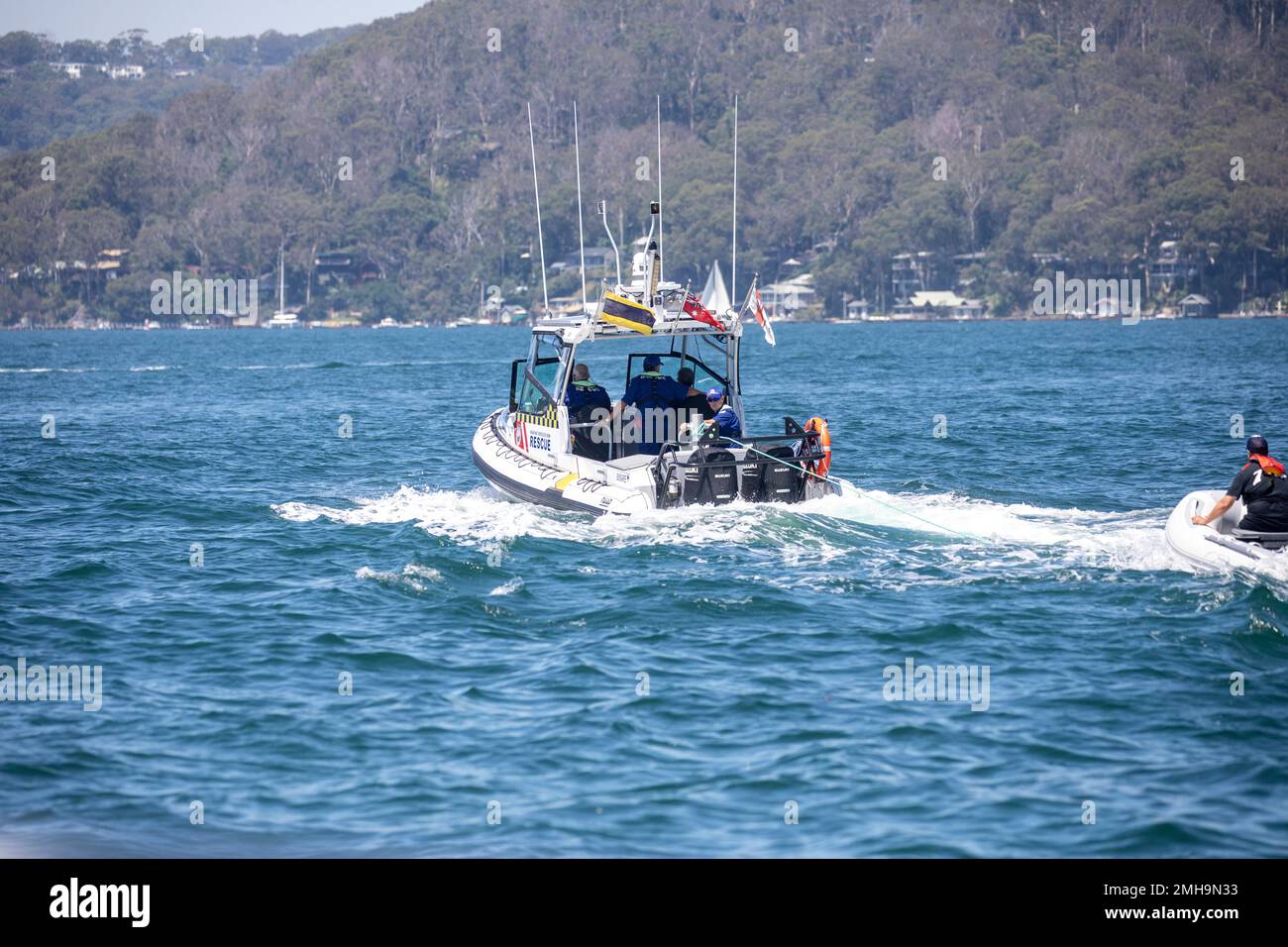 Marine Rescue NSW volunteer staff, rescue a small dinghy boat on ...
