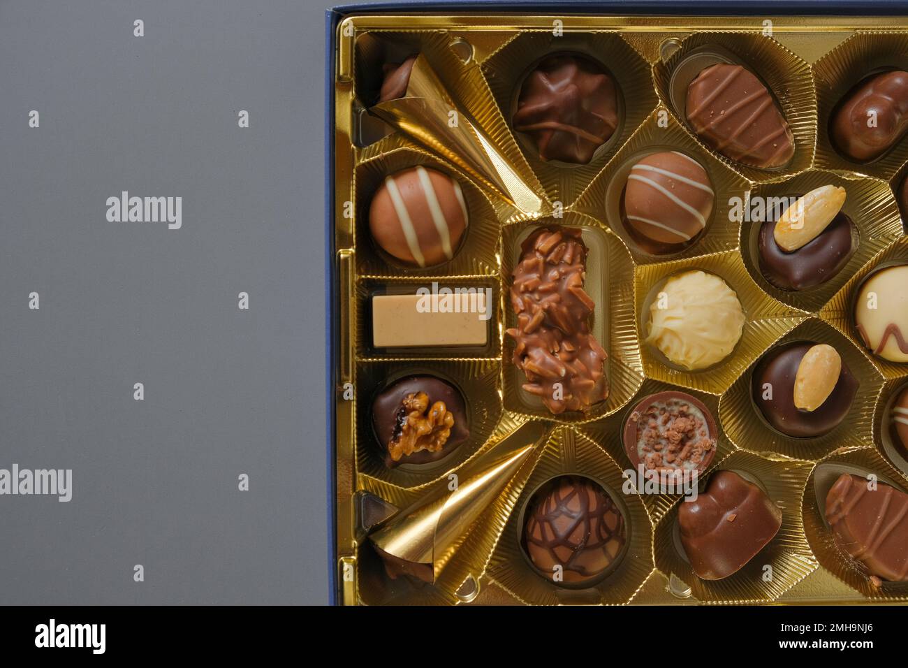Chocolate box. Assorted chocolate candies on a gray background. Milk ...