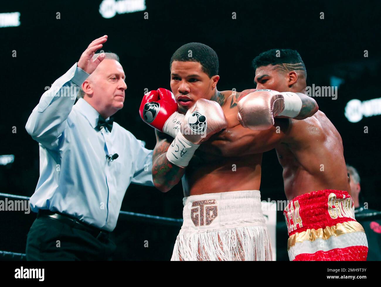 Yuriorkis Gamboa, right, wraps up opponent Gervonta Davis, center, as ...