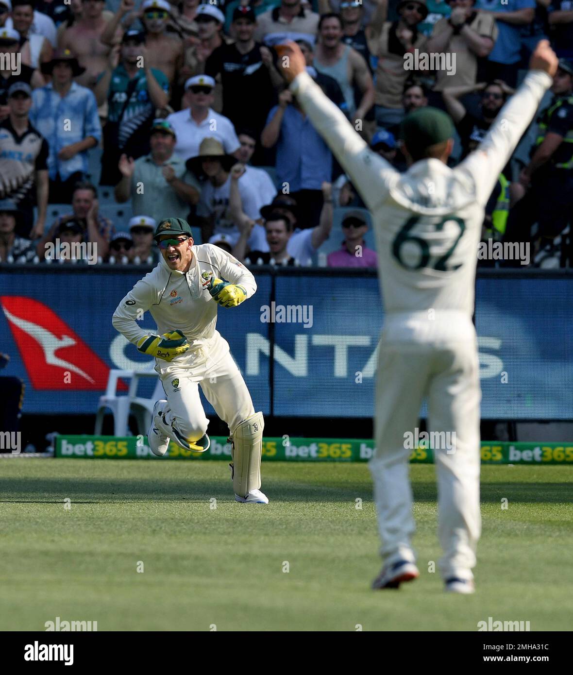 Australia's Tim Paine, left celebrates after catching out New Zealand's ...