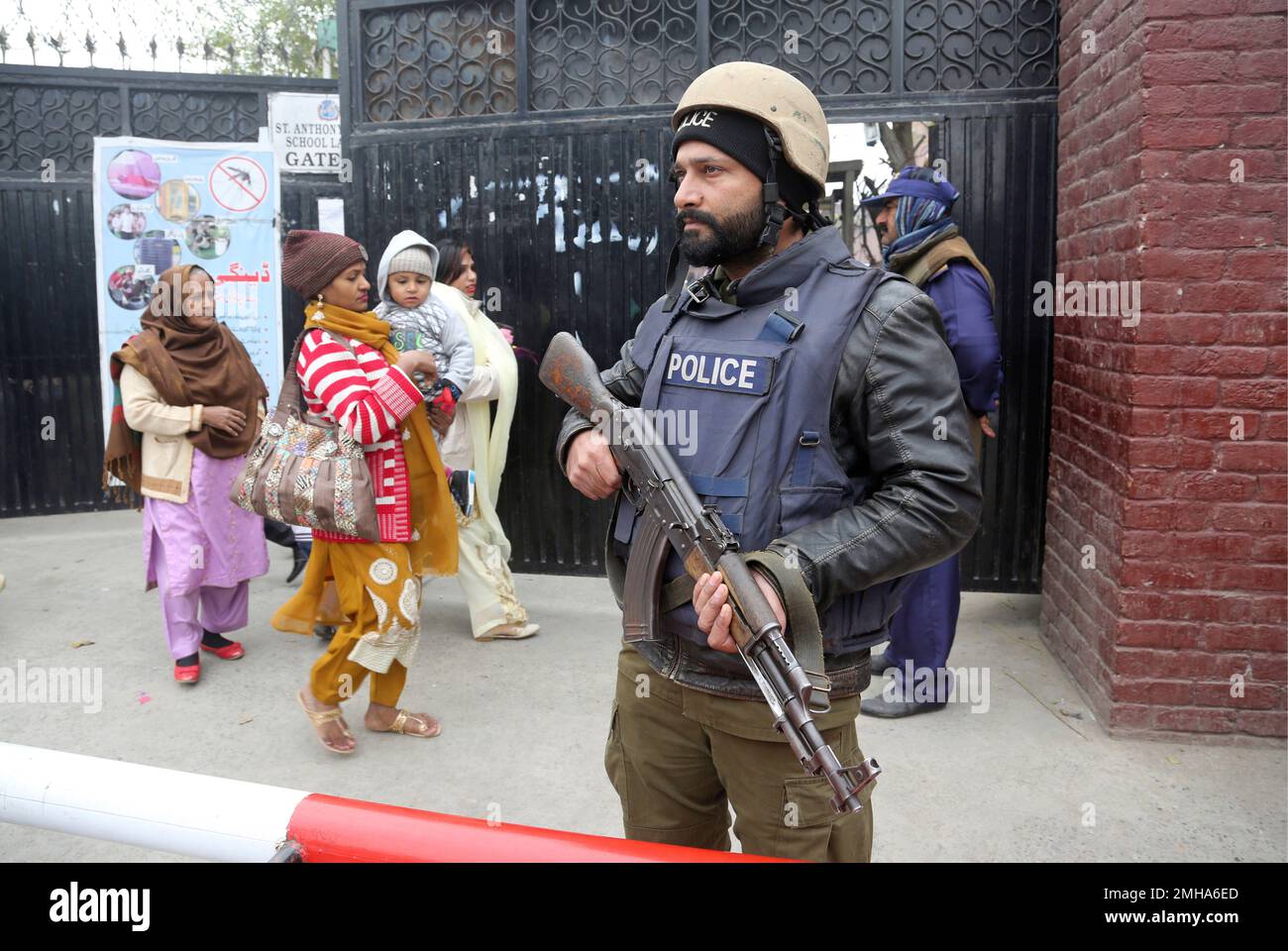 A police commando stands guard outside a church during Christmas Mass ...