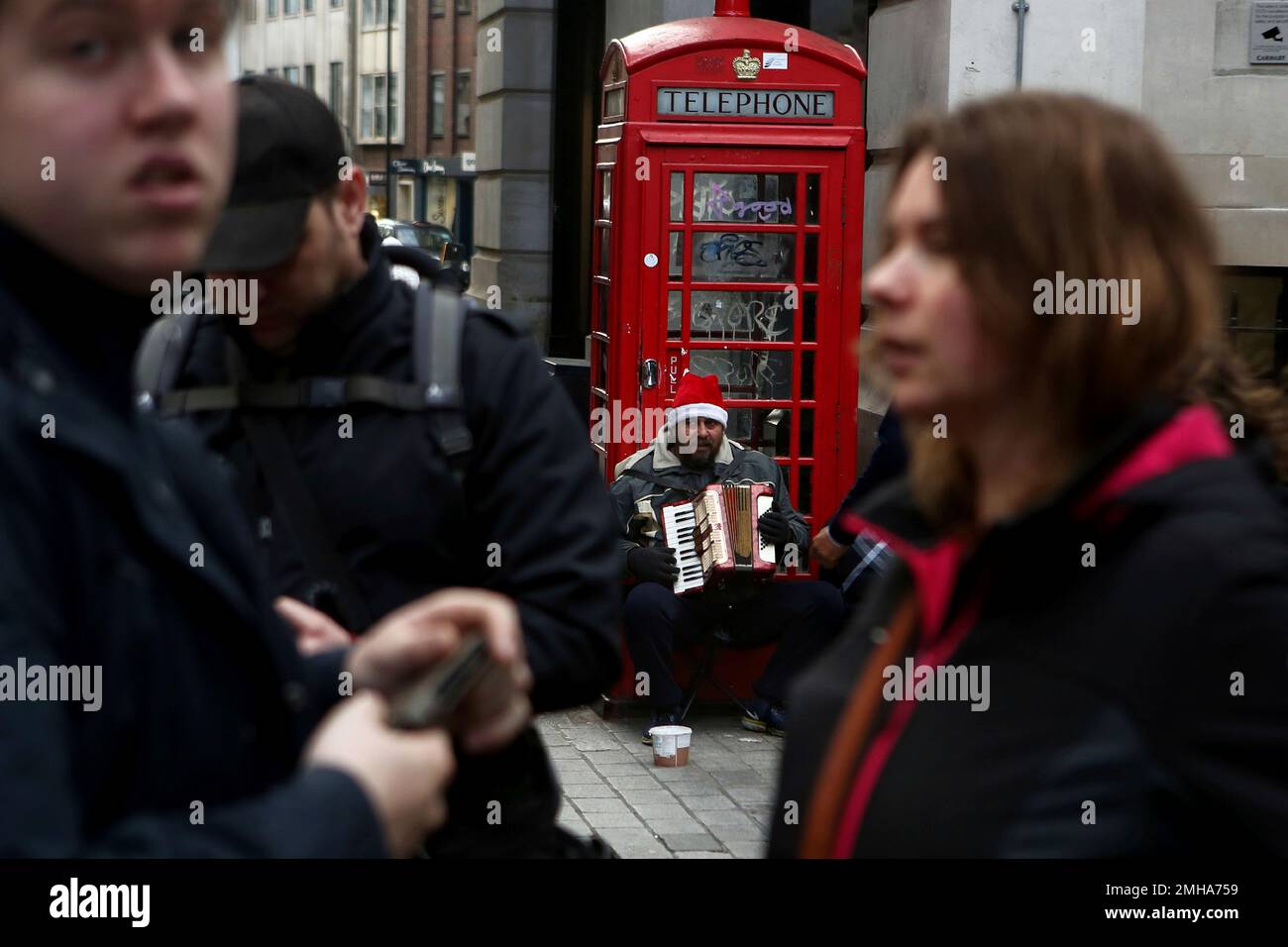 A man plays Christmas songs on his accordion in central London, England ...