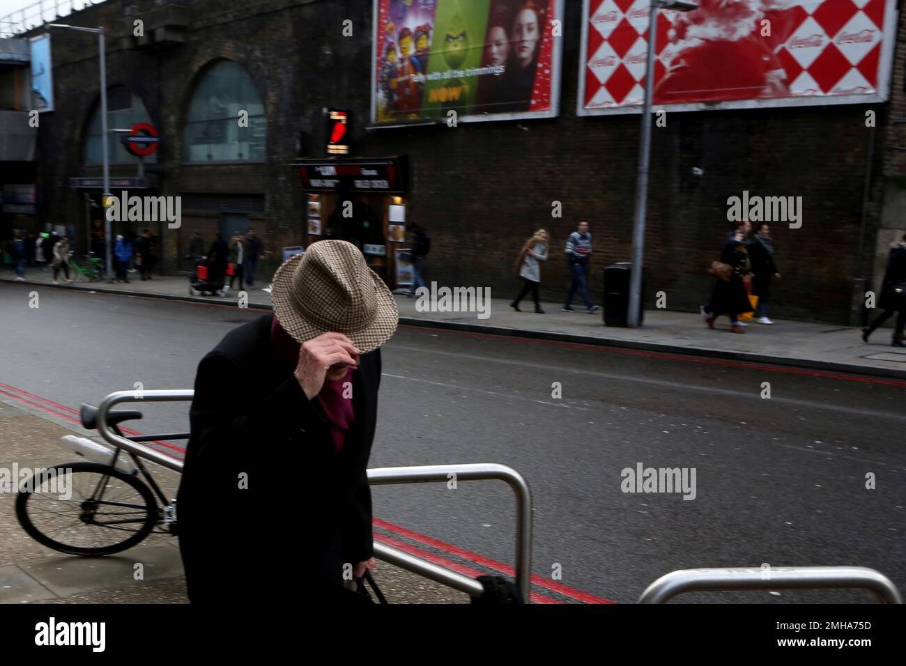 An elderly man walks by London Bridge underground station in central ...