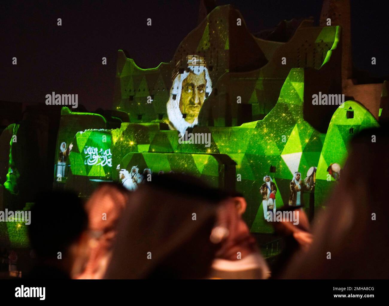 In this Dec. 13, 2019 photo, visitors watch the light illuminating ...