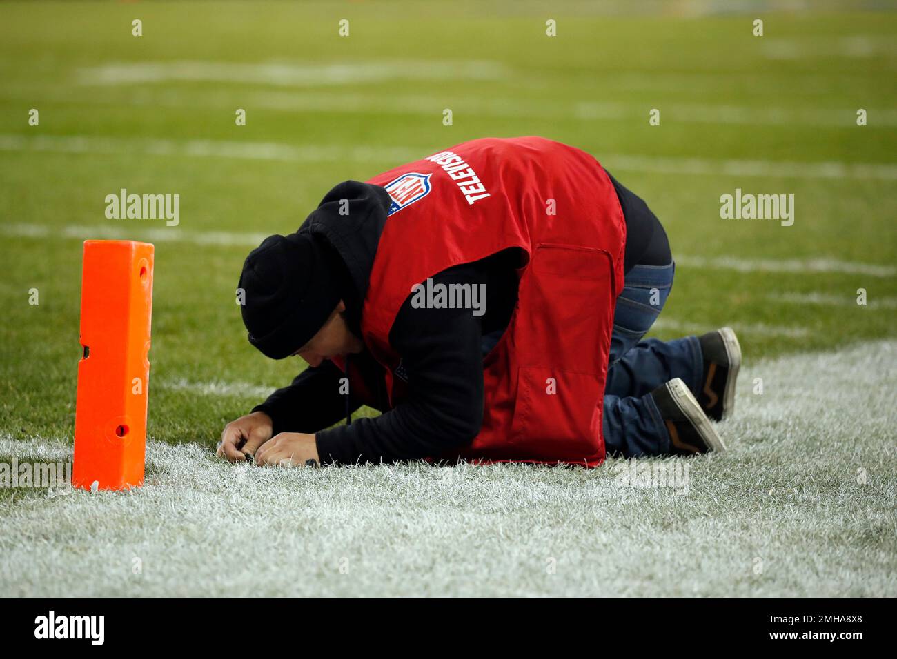 A television technician works on the pylon camera during an NFL ...