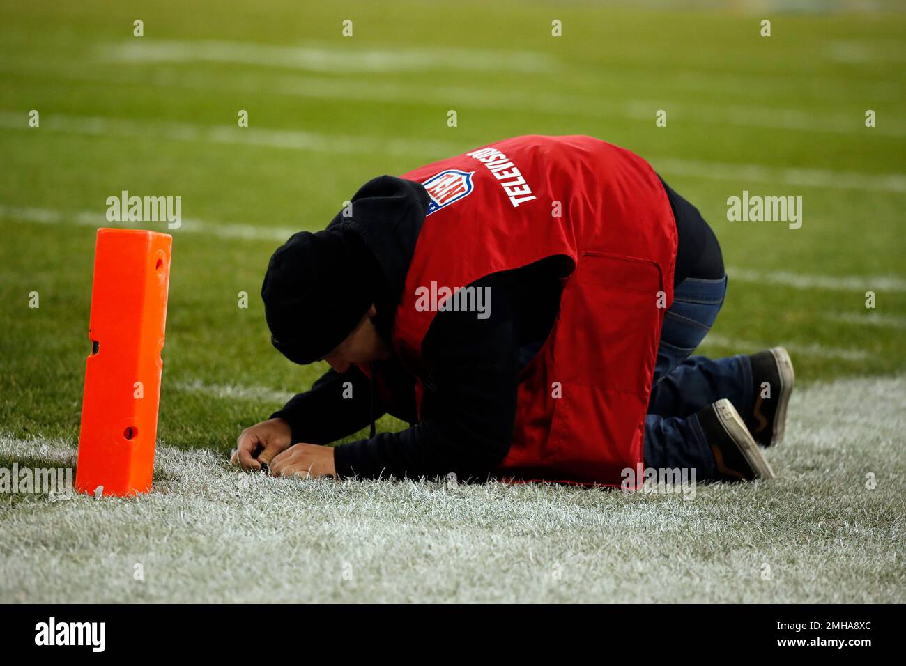 A television technician works on the pylon camera during an NFL ...