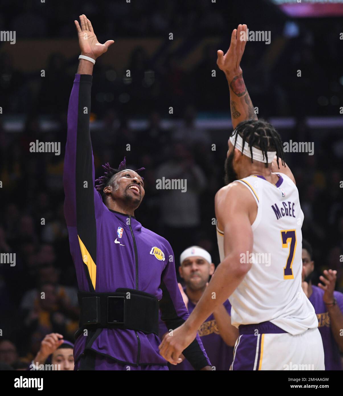 Los Angeles Lakers' Dwight Howard, left, high fives center JaVale McGee ...