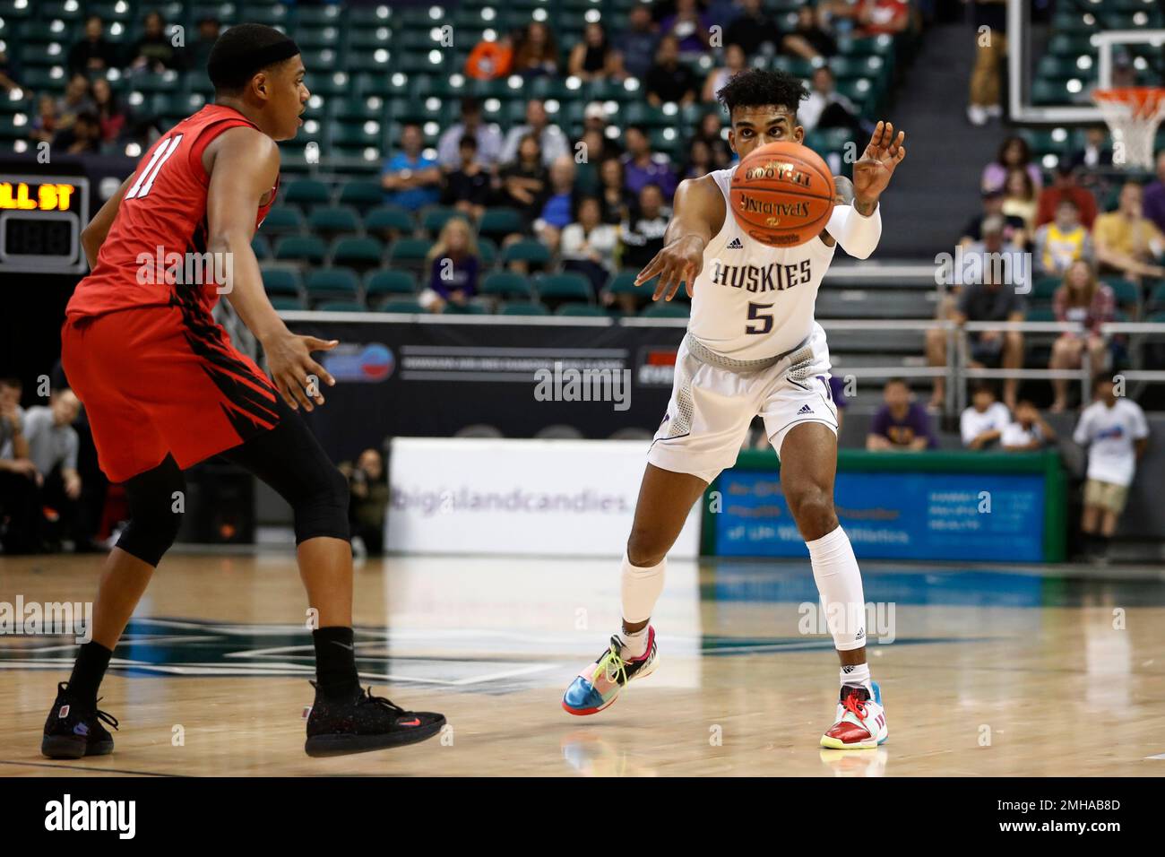 Washington guard Jamal Bey (5) makes a pass by Ball State guard Jarron ...
