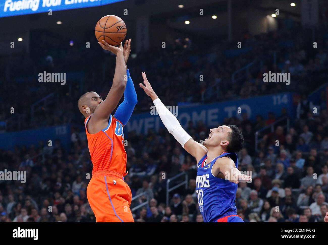 Oklahoma City Thunder guard Chris Paul, left, shoots as Los Angeles ...