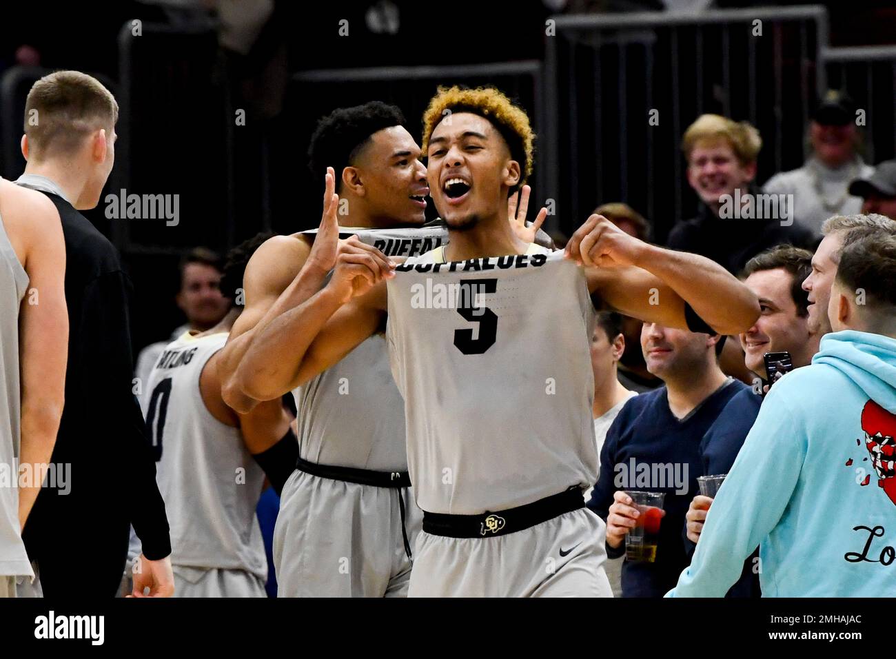 Colorado guard D'Shawn Schwartz (5) and guard Tyler Bey, back, react ...