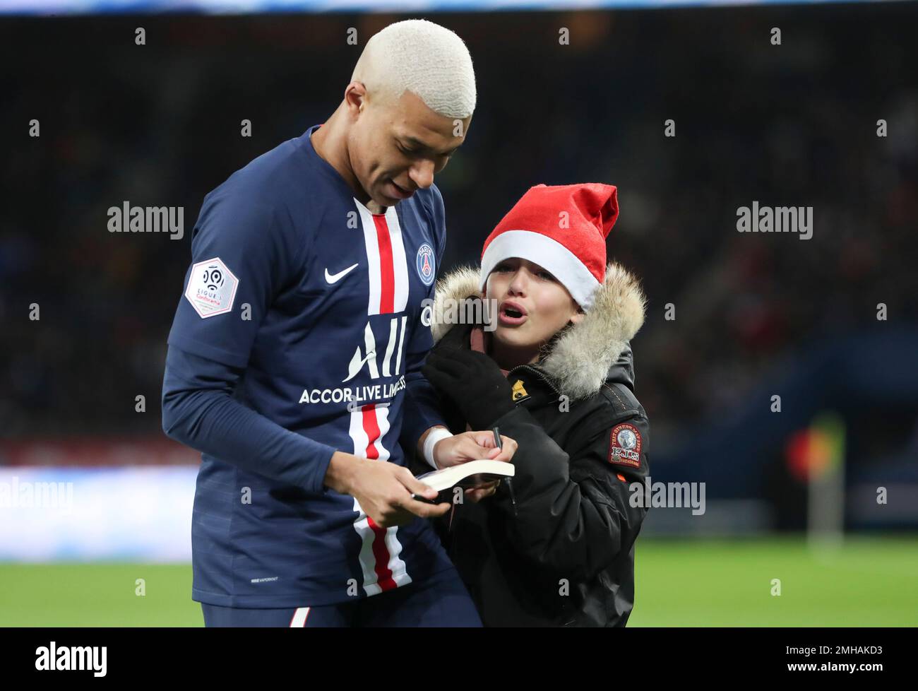 A young boy in a Santa Claus headgear stops the game as he takes a ...
