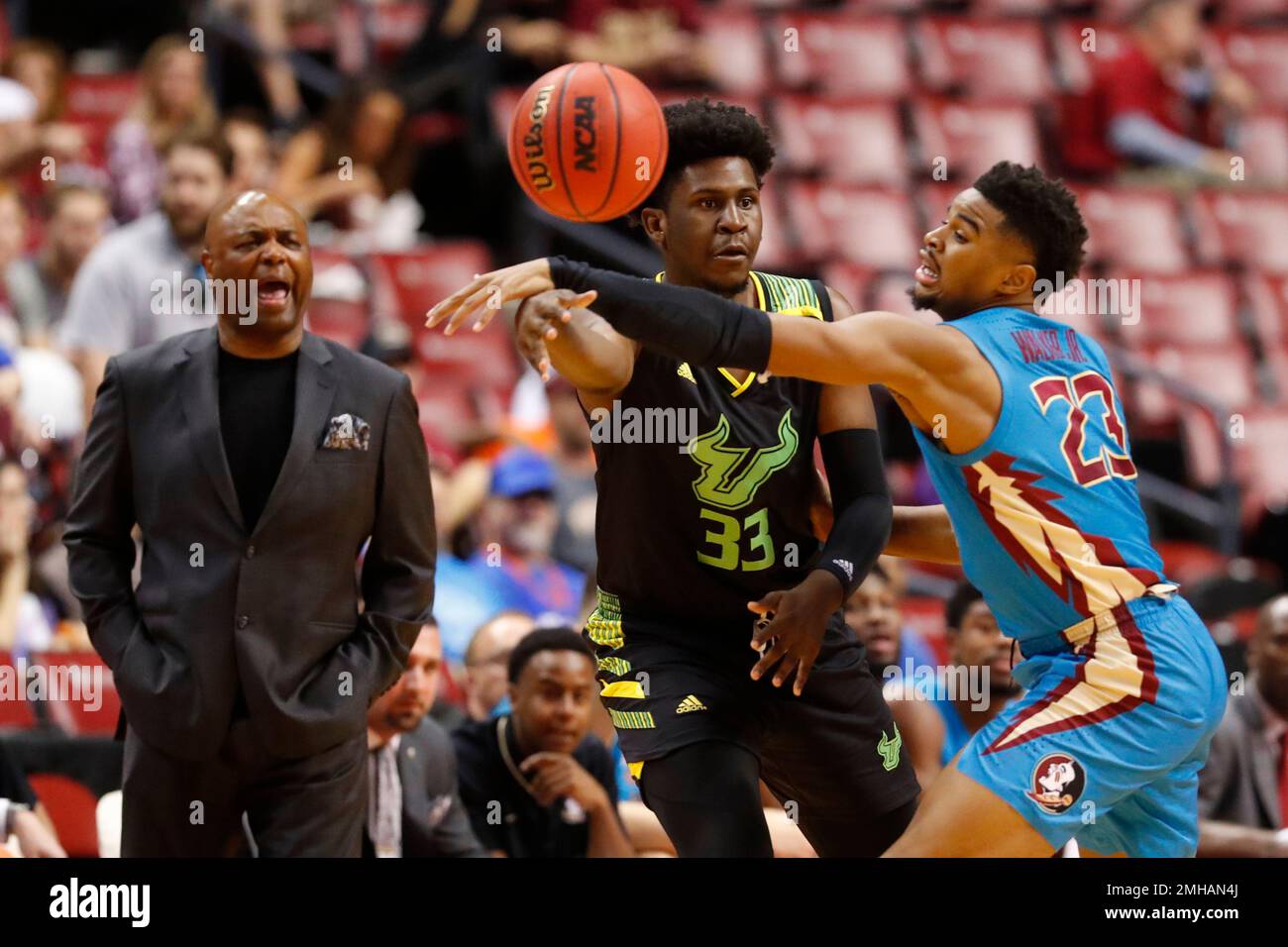 South Florida forward B.J. Mack (33) passes past Florida State guard M ...