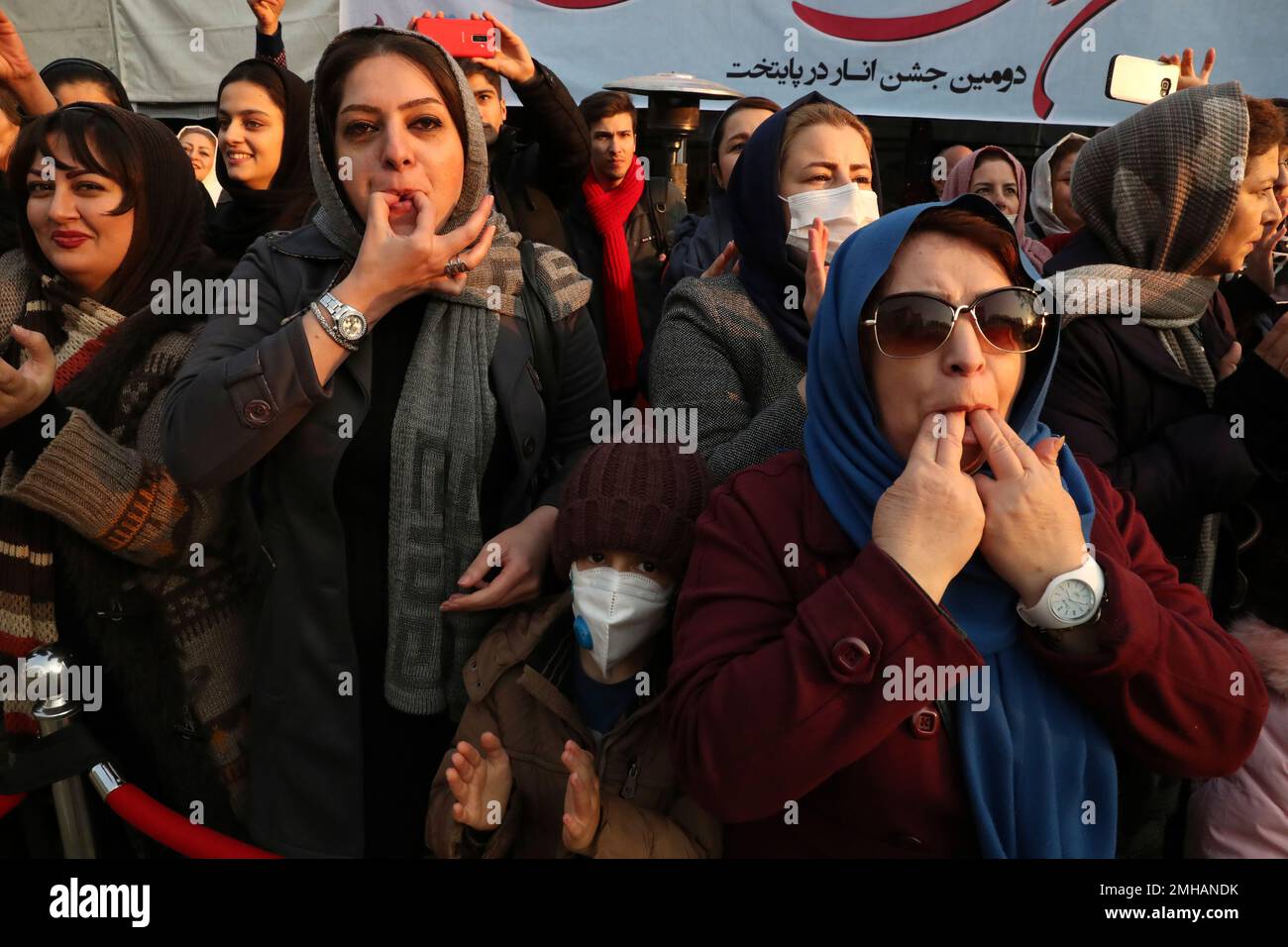 Spectators cheer as Iranian Kurd performers dance a traditional Kurdish ...
